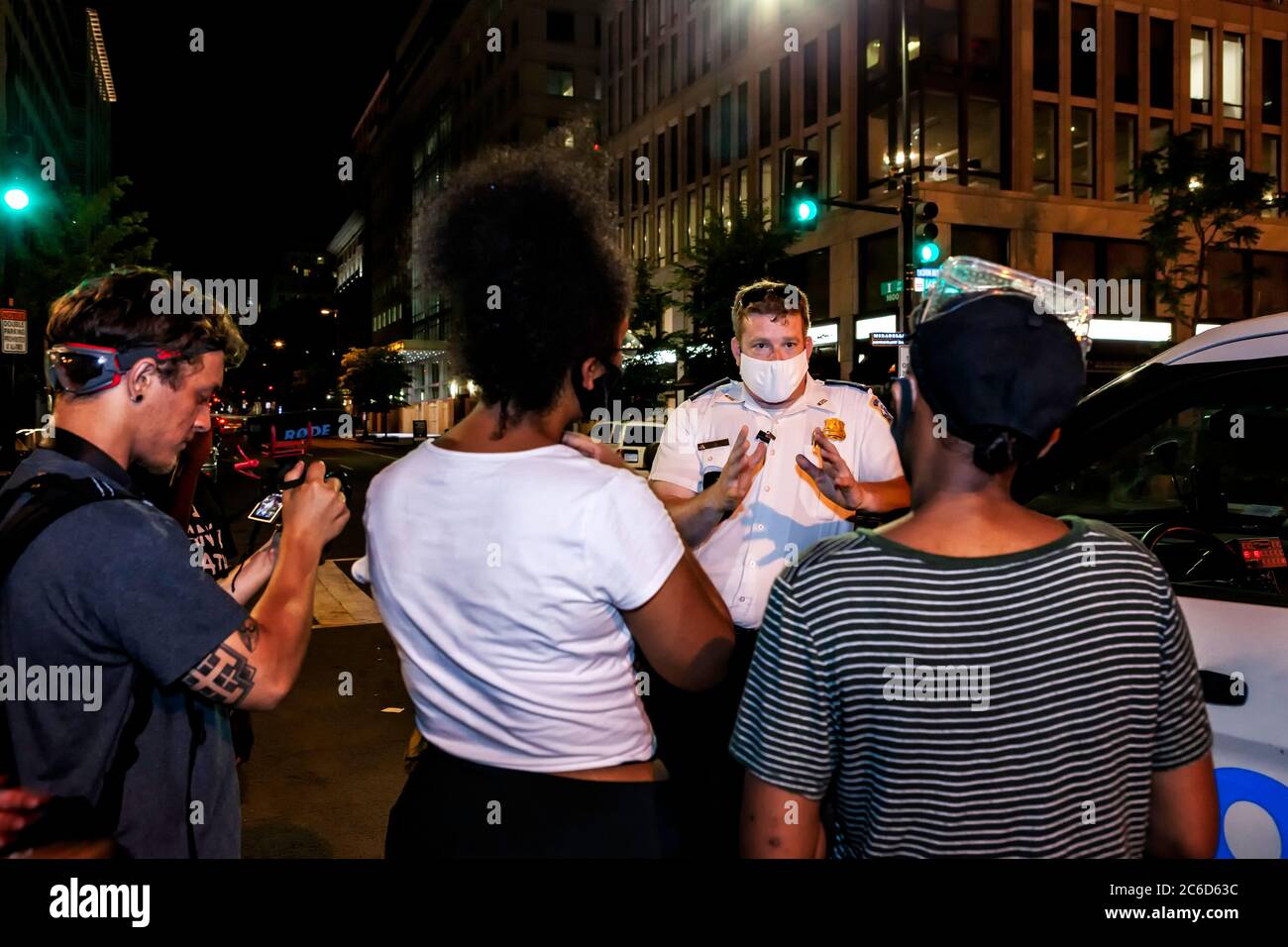 DC police Lt. Bagshaw speaks with protesters at BLM Plaza about their ...