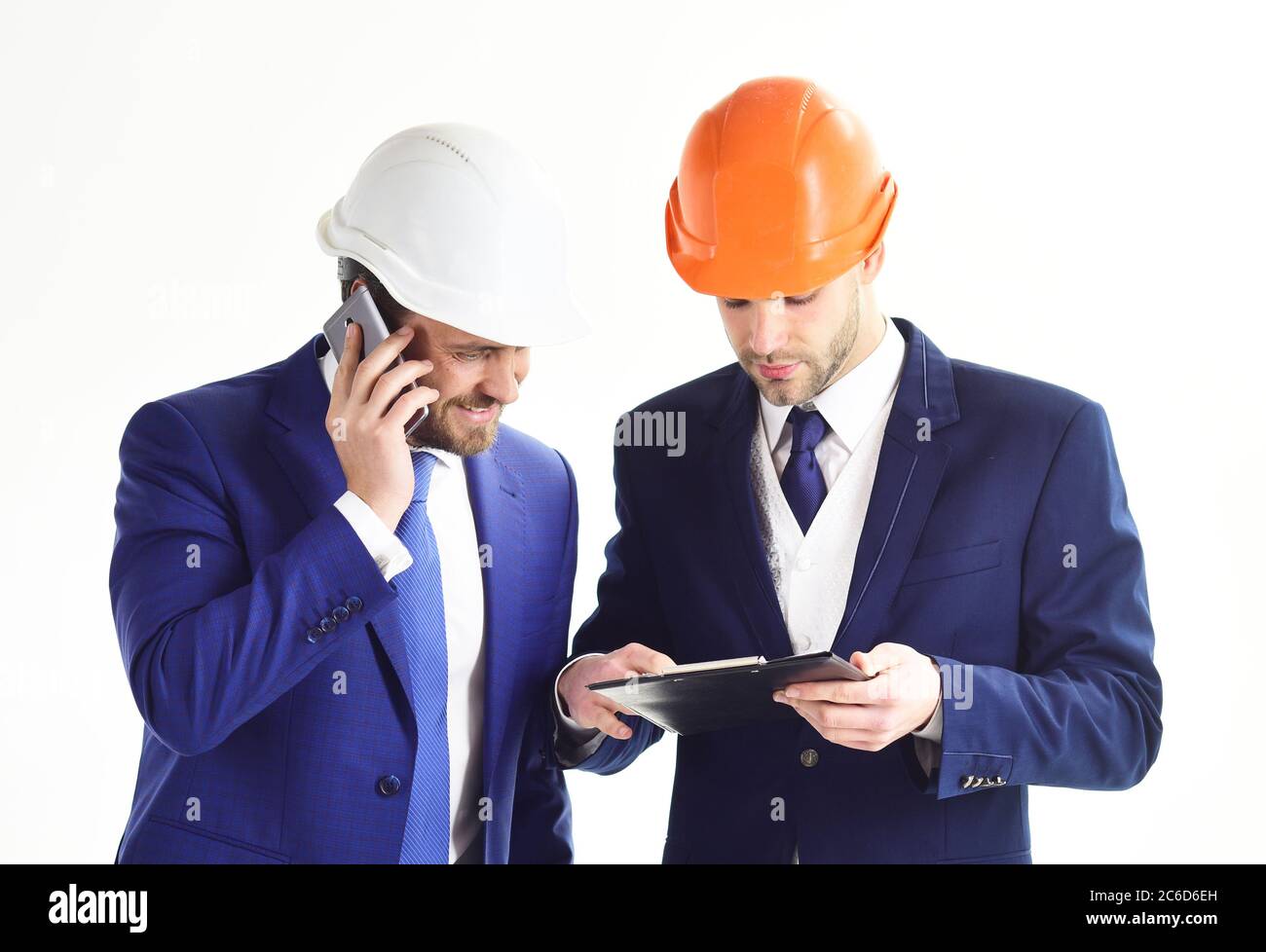 Entrepreneur and architect with plans and smartphone. Construction ...