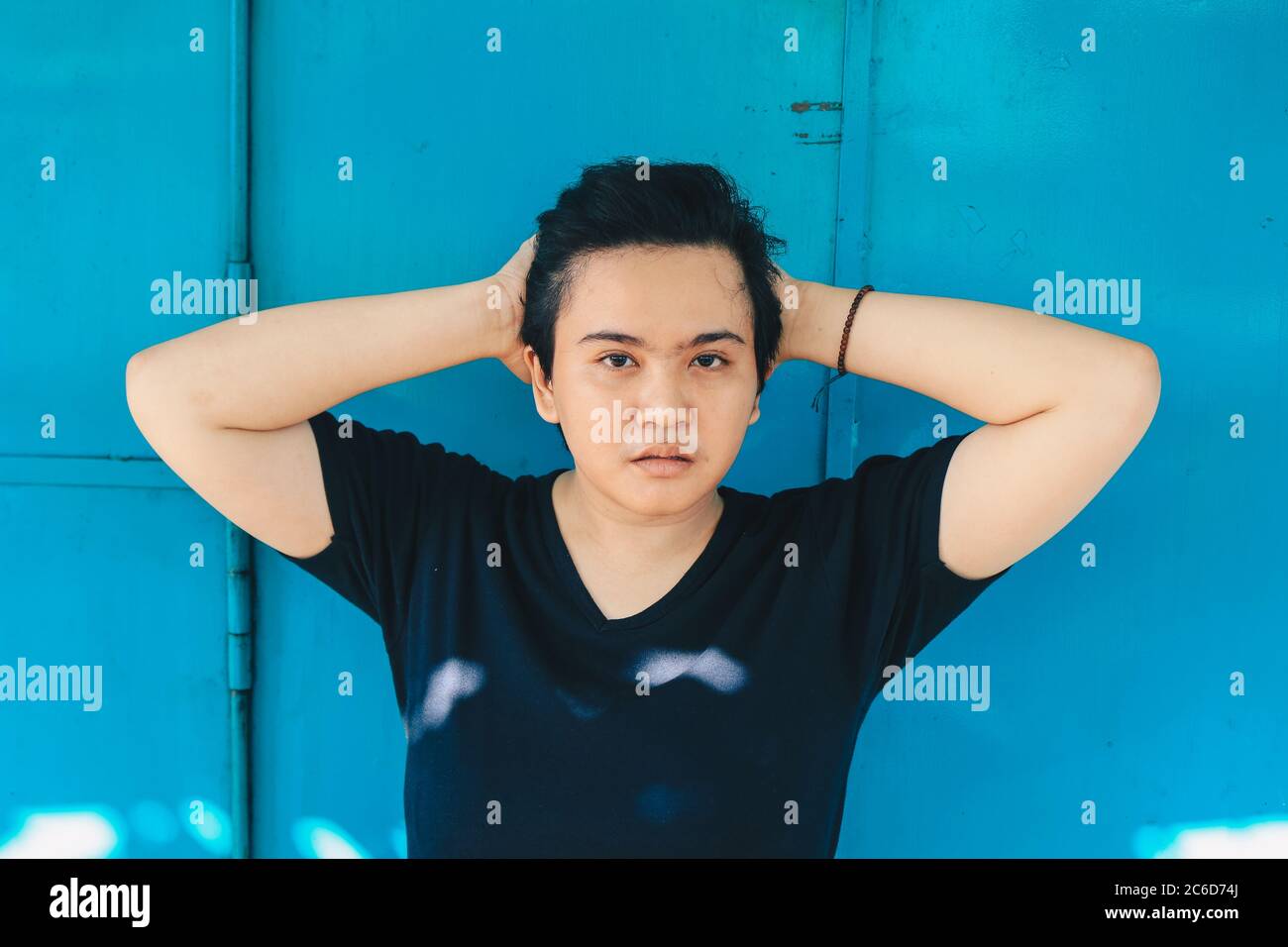 Asian beautiful short hair girl on blue background with sharp looking ...