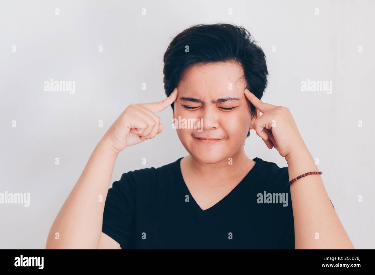 Asian beautiful smiling girl with short hair is thinking and ...