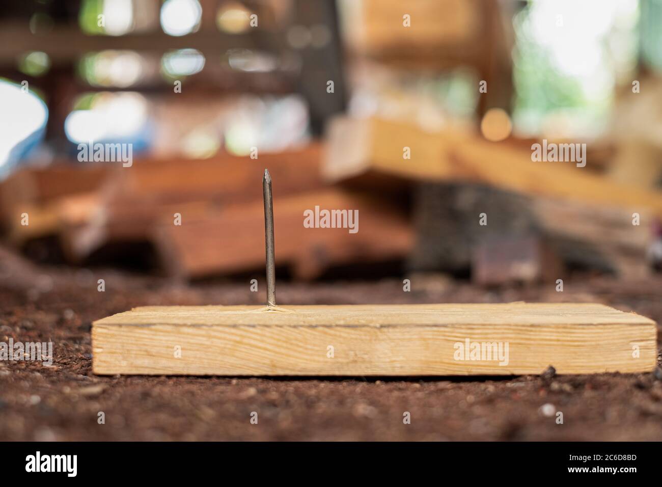 Nail on board wood In the construction area Stock Photo - Alamy