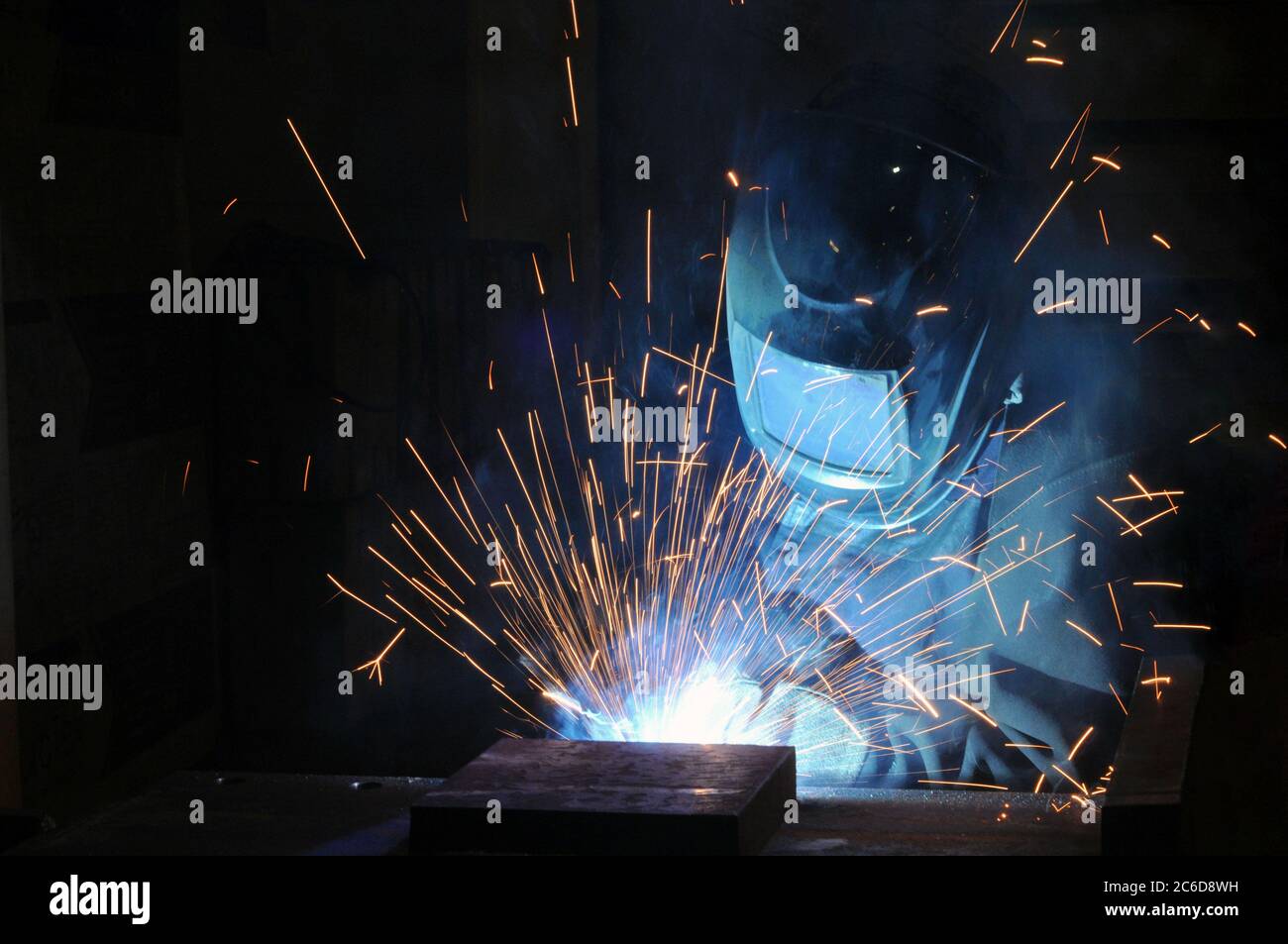 The welder at the factory is engaged in the production of metal ...