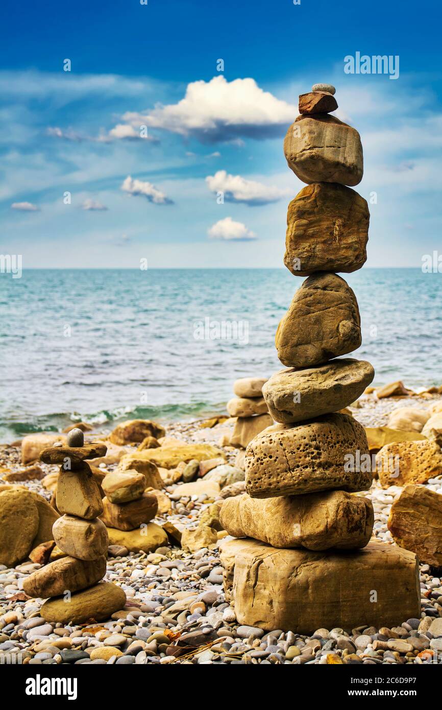 Pyramid of sea stones on the seashore at the pebble beach. Concept of ...