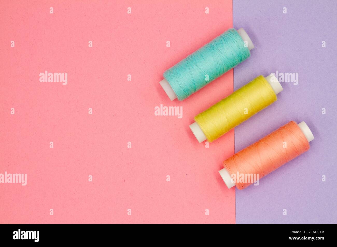 Top view of multi-colored sewing reels on a colored background. Hobby ...