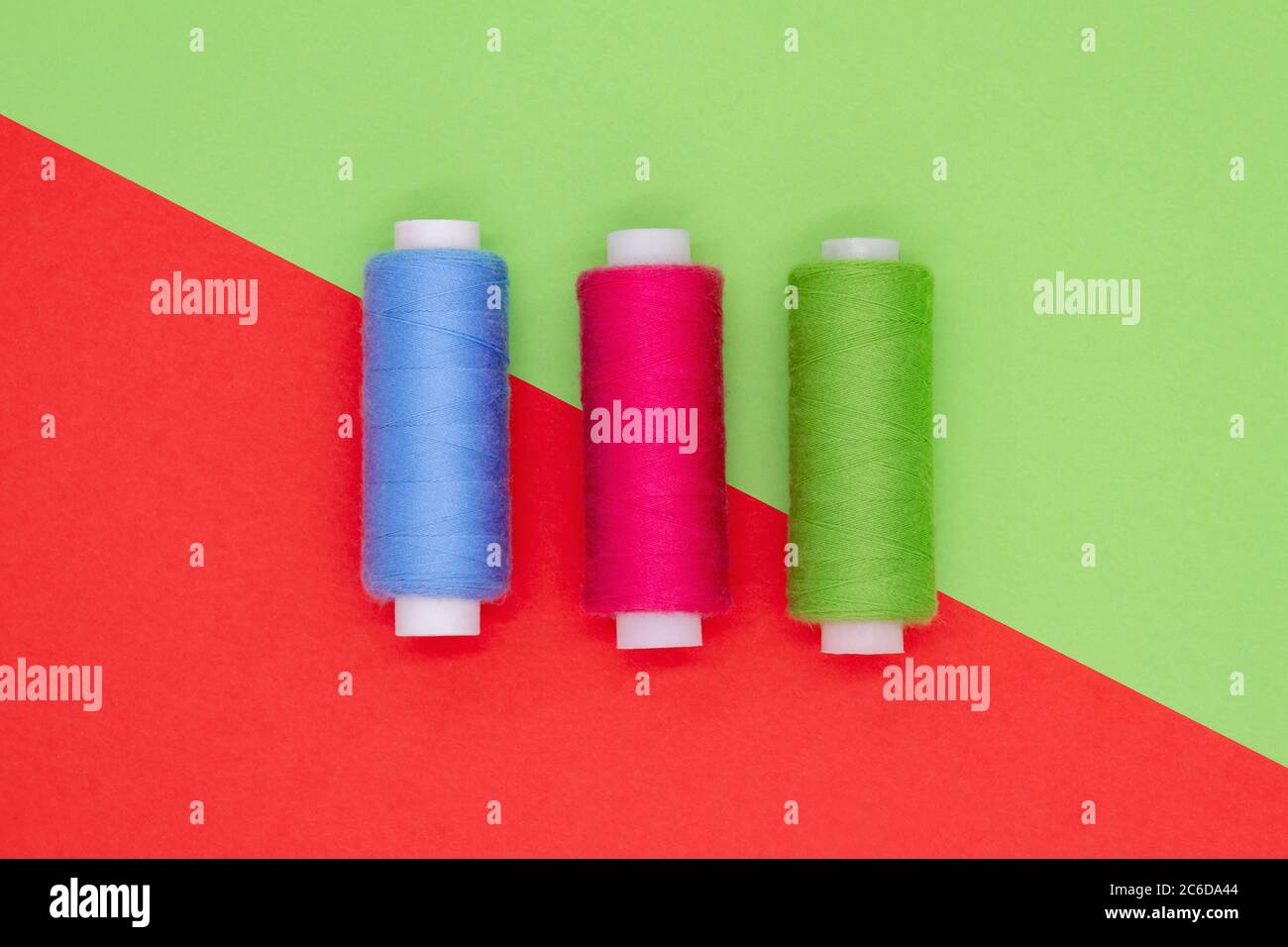 Top view of multi-colored sewing reels on a colored background. Hobby ...