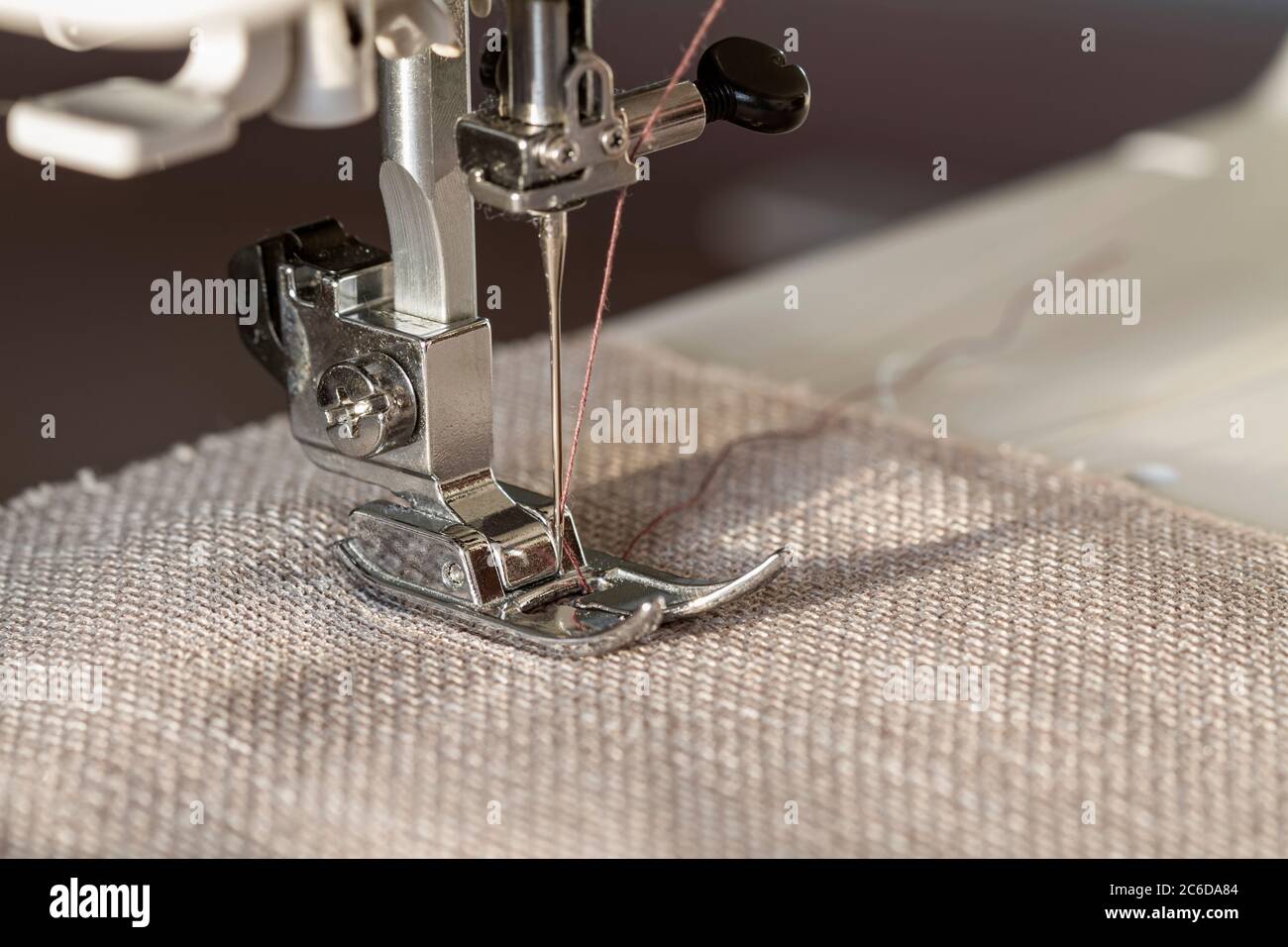 Closeup of sewing machine working part with beige fabric Stock Photo ...