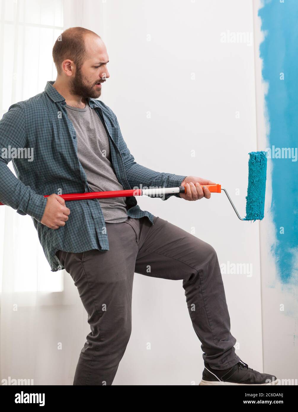 Guy singing during home repair hi-res stock photography and images - Alamy