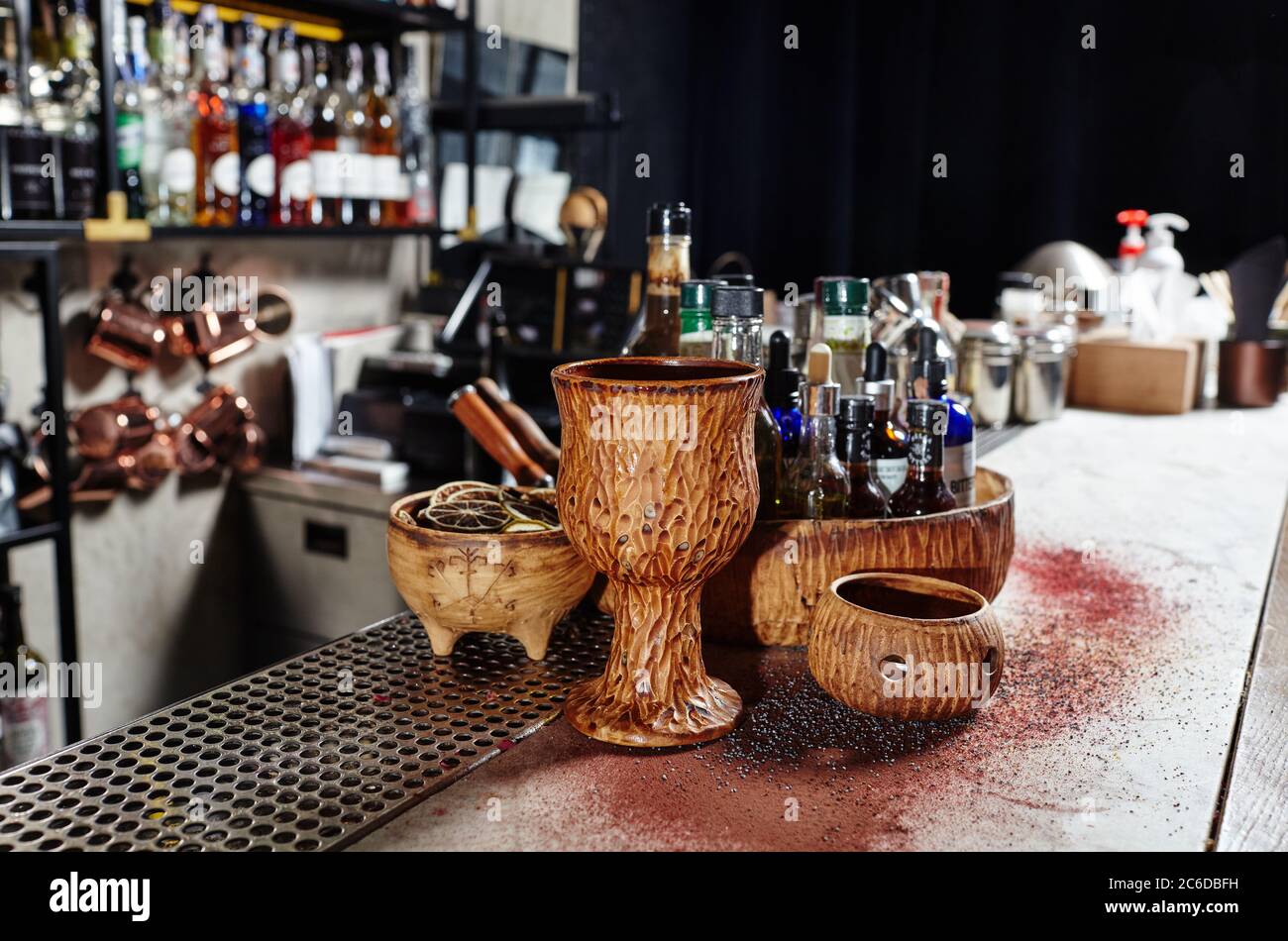 Ingredients for cocktails in small bottles.Shakers and lemon wedges on ...