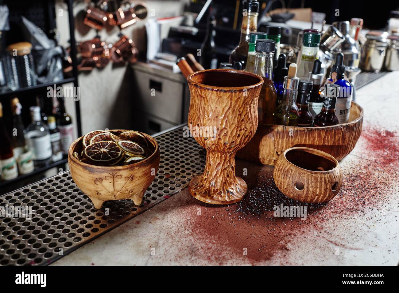 Ingredients for cocktails in small bottles.Shakers and lemon wedges on ...
