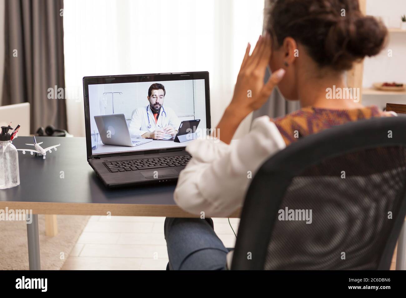Female patient in a video call with her doctor from home Stock Photo ...