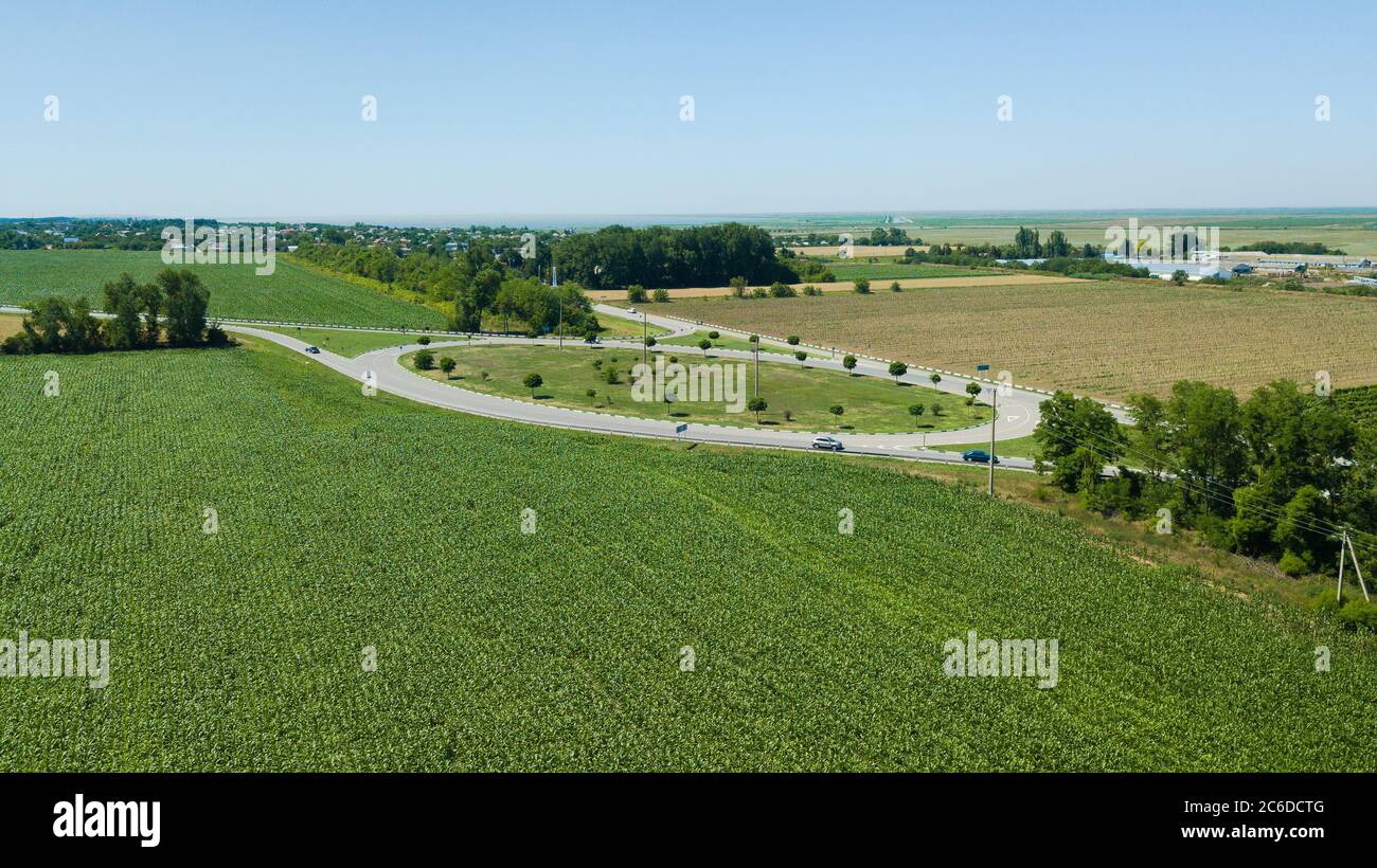 Aerial view of a country road in beautiful agricultural fields in ...