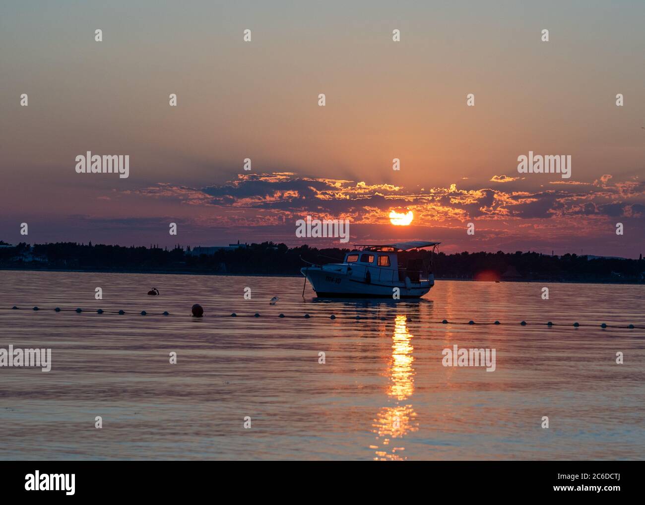 Boat in the sunrise Stock Photo - Alamy