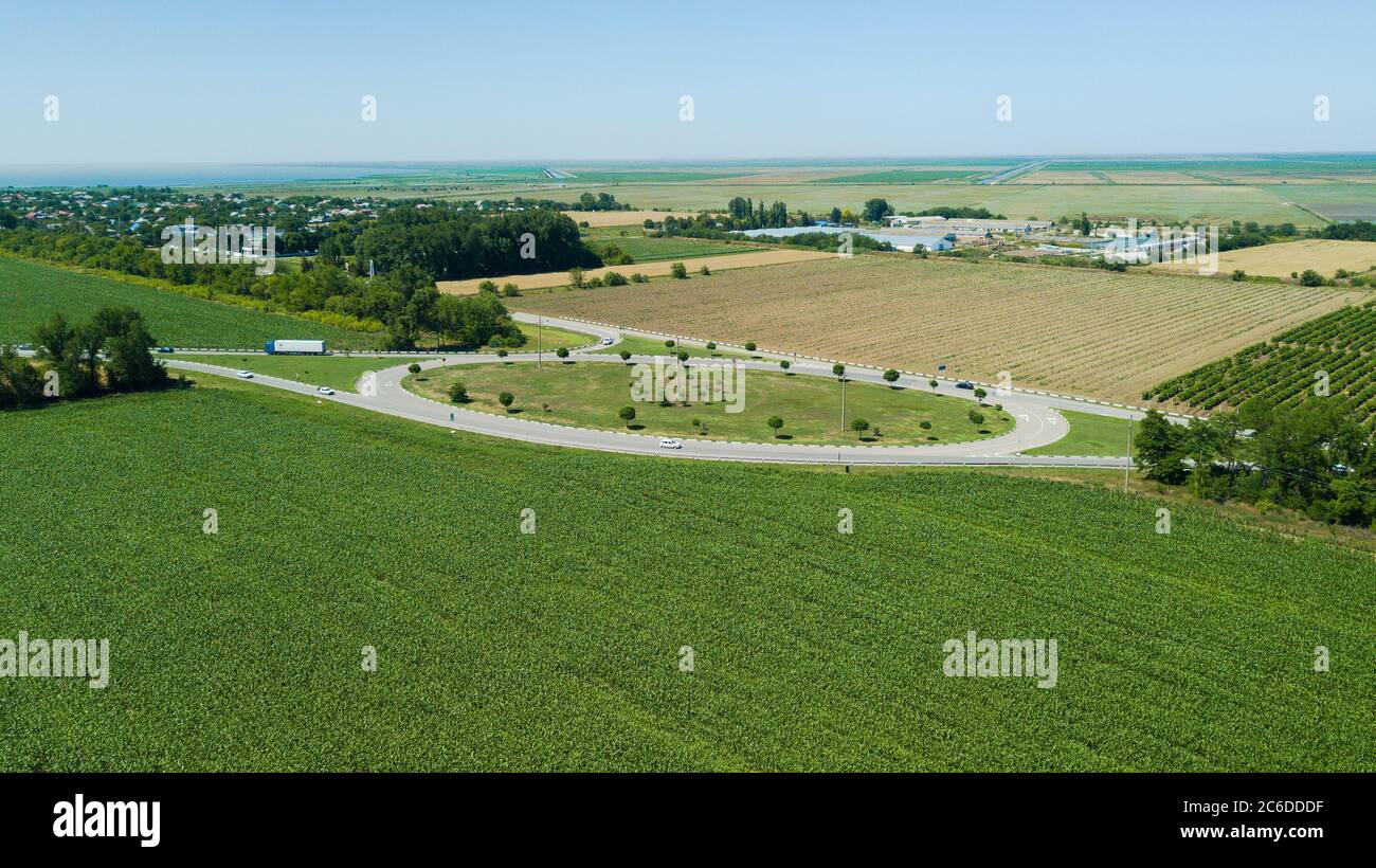 Aerial view of a country road in beautiful agricultural fields in ...