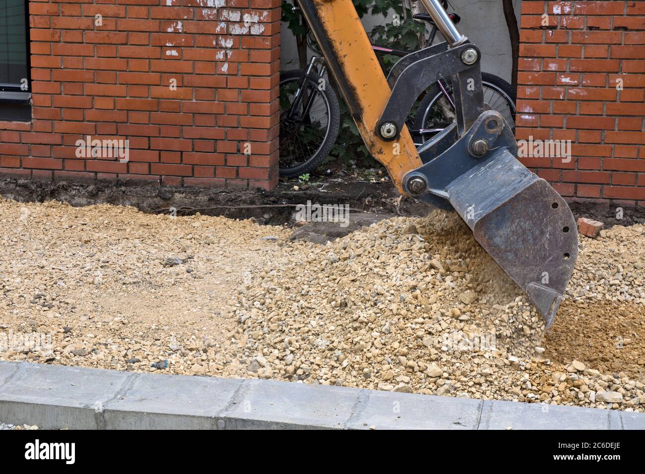The excavator works on the street and prepares the ground for laying ...