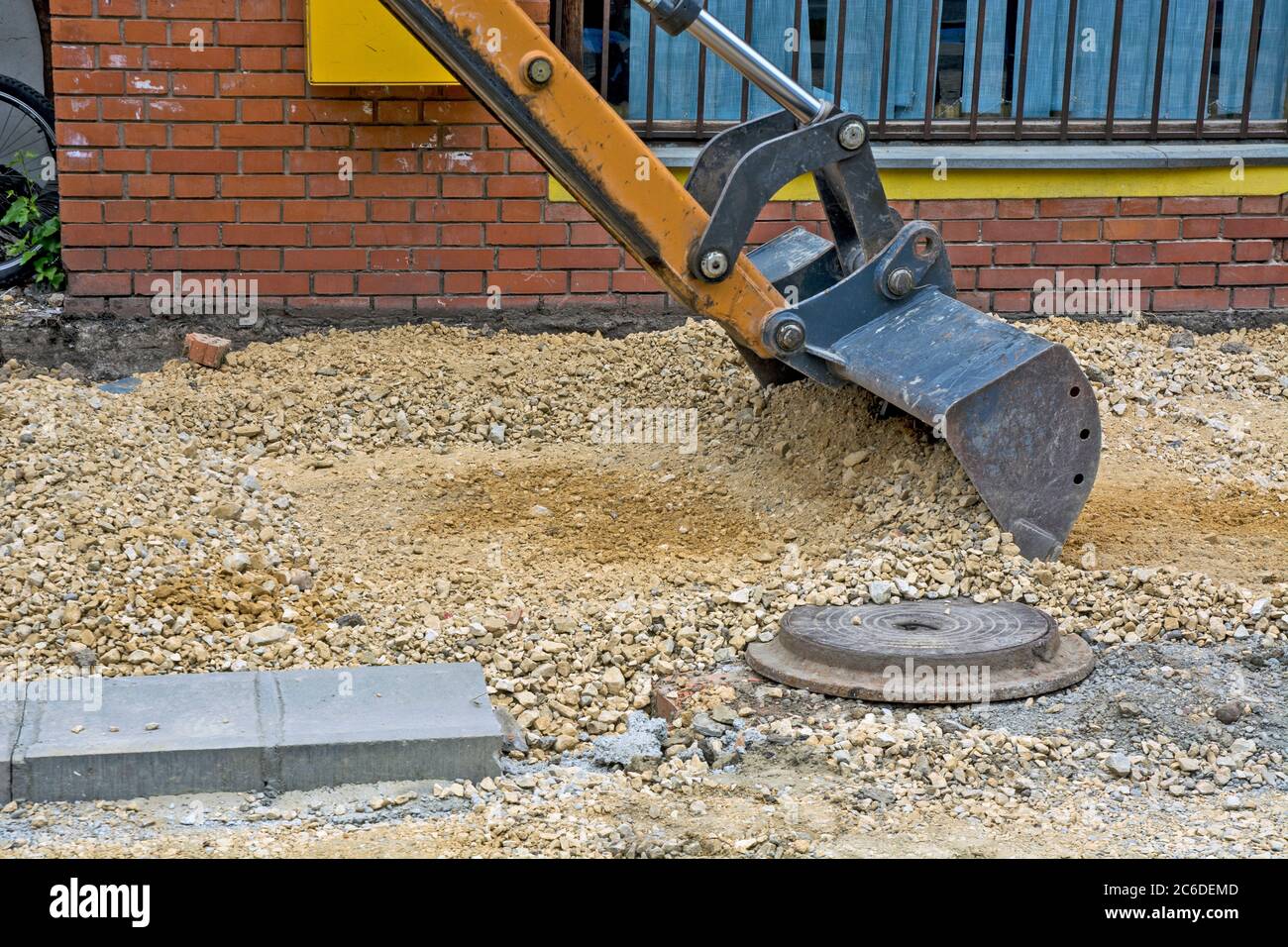 The excavator works on the street and prepares the ground for laying ...