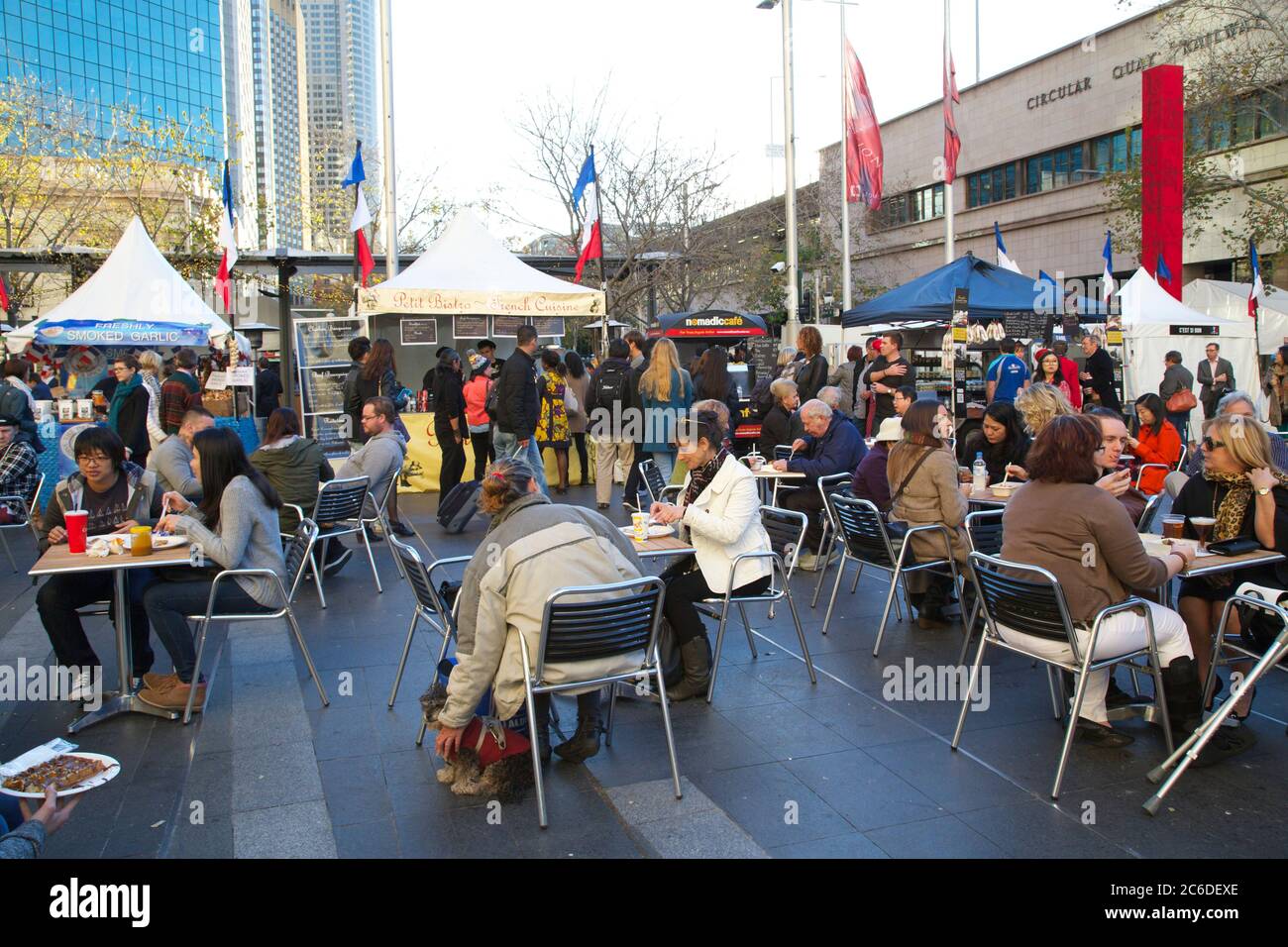People sit around tables outside eating French cuisine at the ‘Bleu ...