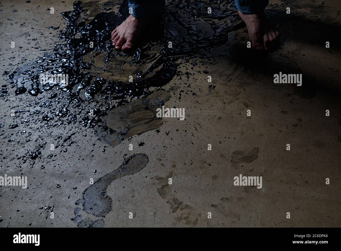 Picture of human's footprint near the black mucky puddle Stock Photo ...