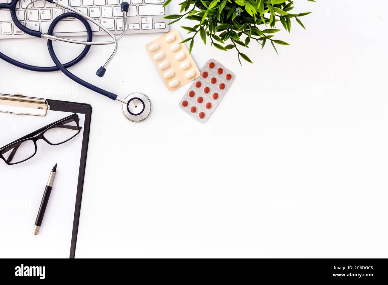 Doctor office desk with medicine and tablet. White table top view copy ...