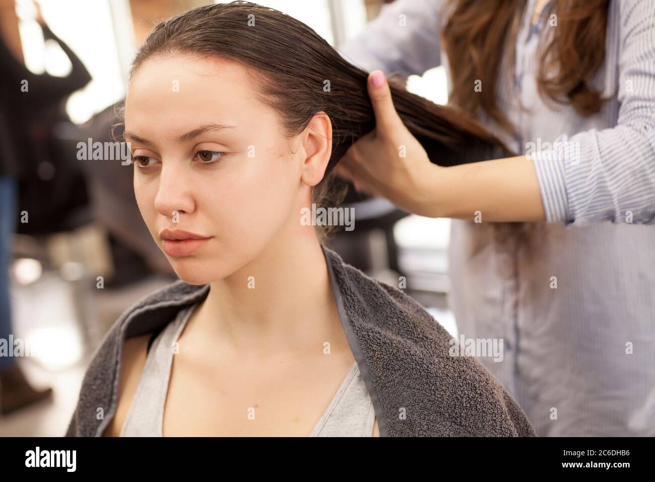 Professional stylist combing long wet hi-res stock photography and ...