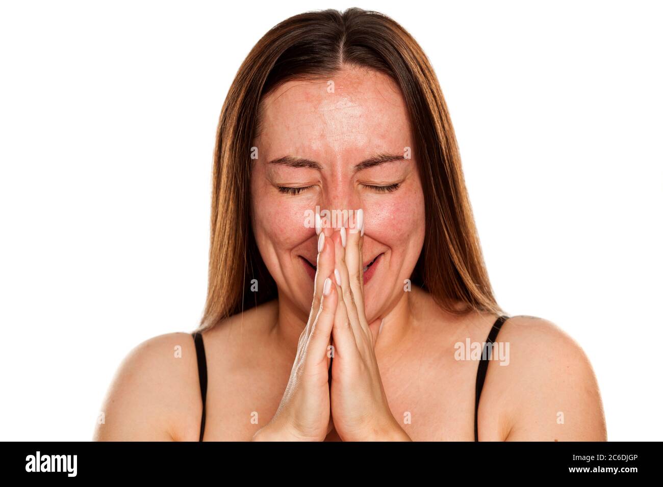 A young woman has itching in the nose on white background Stock Photo ...