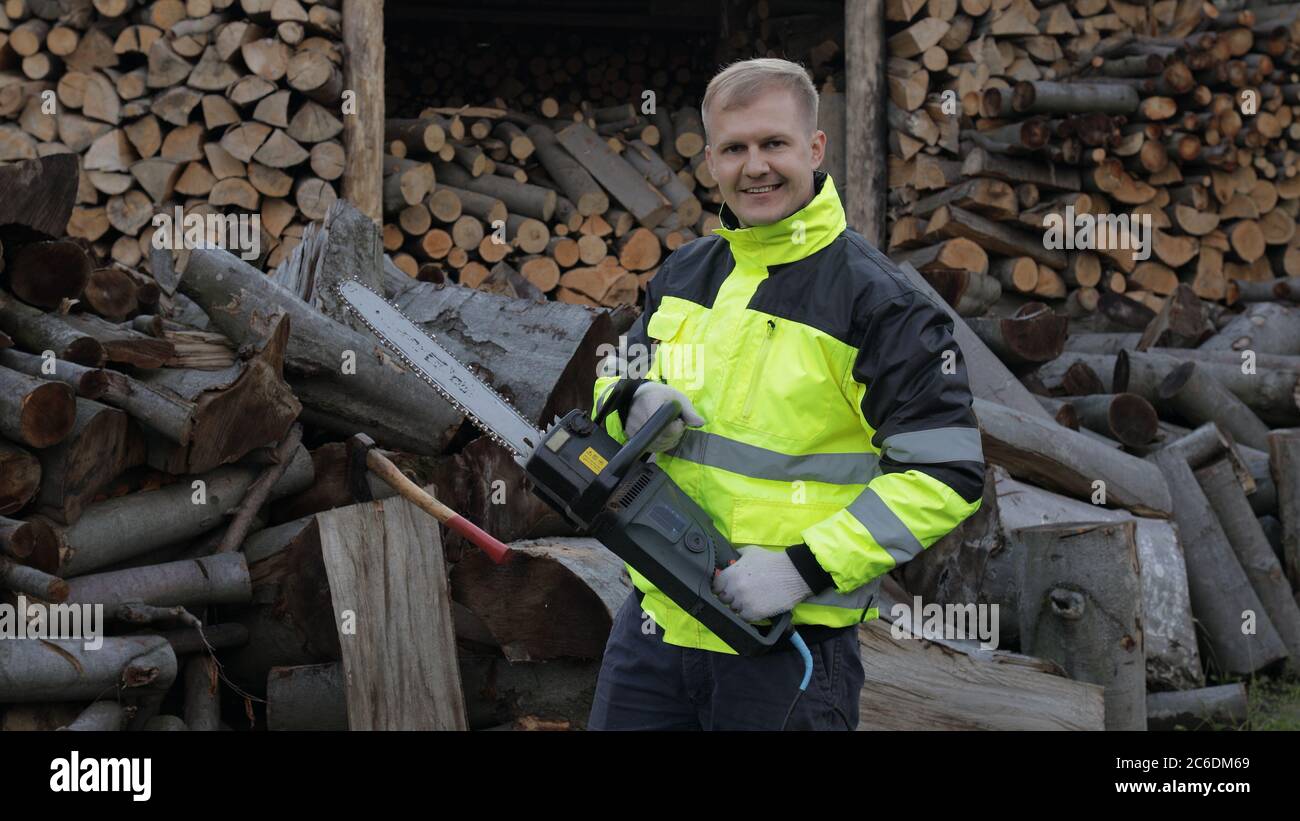 Portrait of lumberjack posing in green jacket with reflective stripes ...