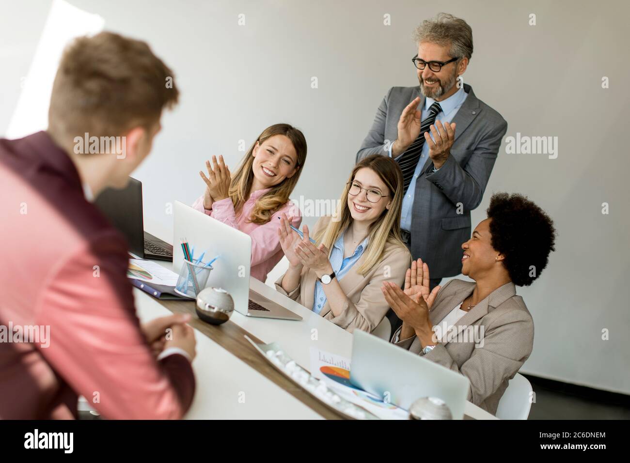 Group of multiethnic business people hear great news while working on ...