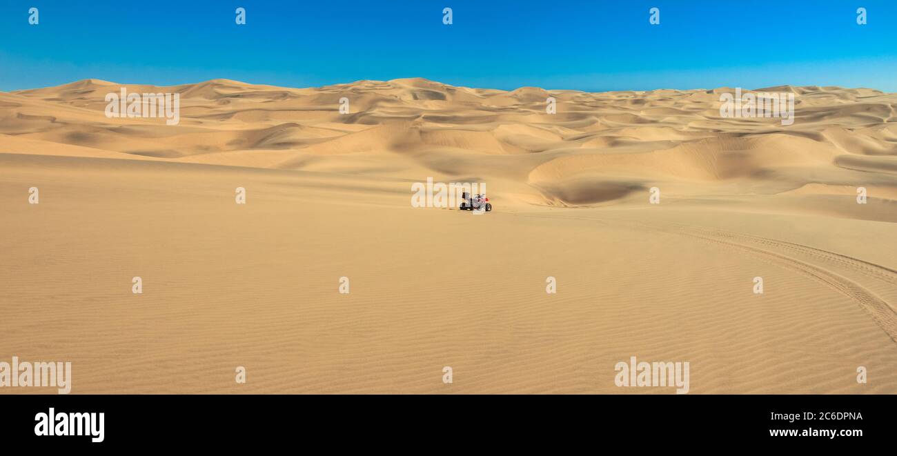 Quad driving in sand desert. ATV standing in middle of nowhere in sand ...