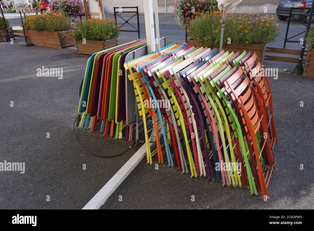 colorful tables and chairs stacked up outdoor Stock Photo - Alamy