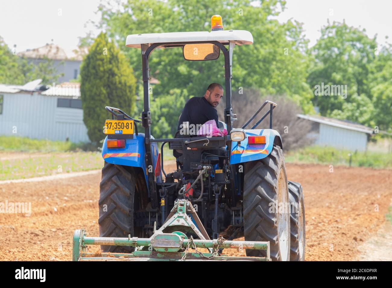An Israeli farmer inspects his farmland Photographed in Haniel [a ...
