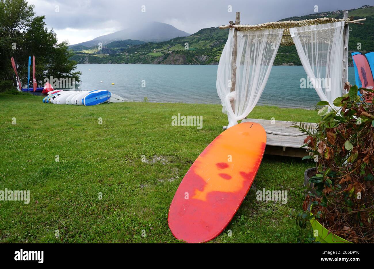 colorful paddle board and outdoor bedding on serre ponçon lake, france ...
