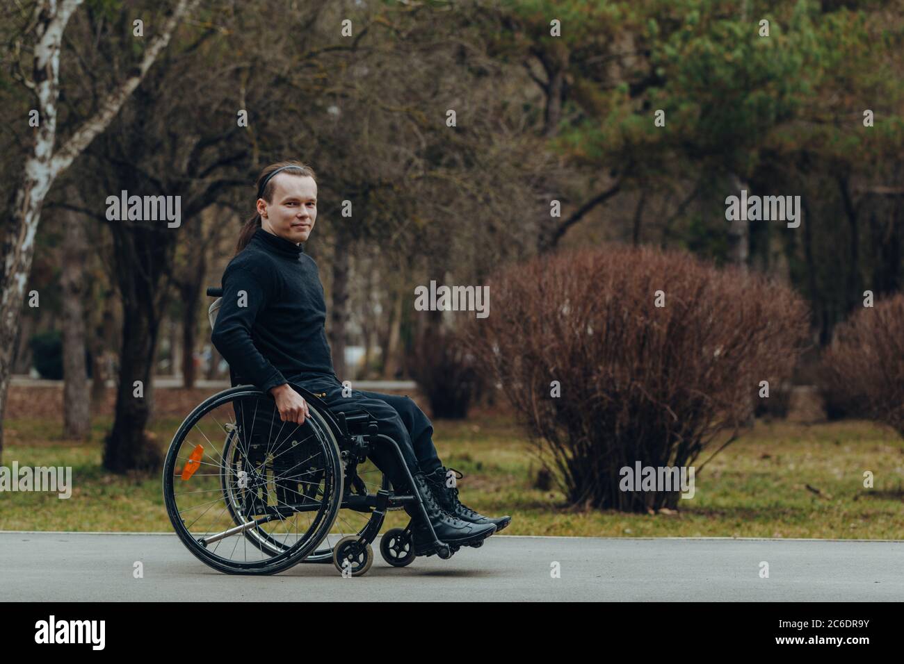 young disabled man in wheelchair walking park Stock Photo - Alamy