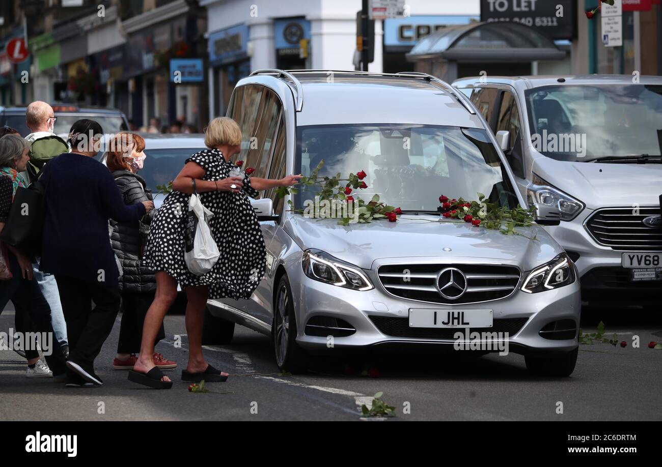 People place flowers on the funeral cortege of Xander Irvine, the three ...