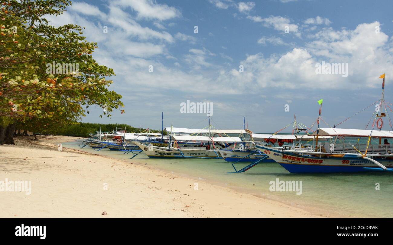 Tourist boats moored on the shore. Cowrie island. Honda Bay. Puerto ...