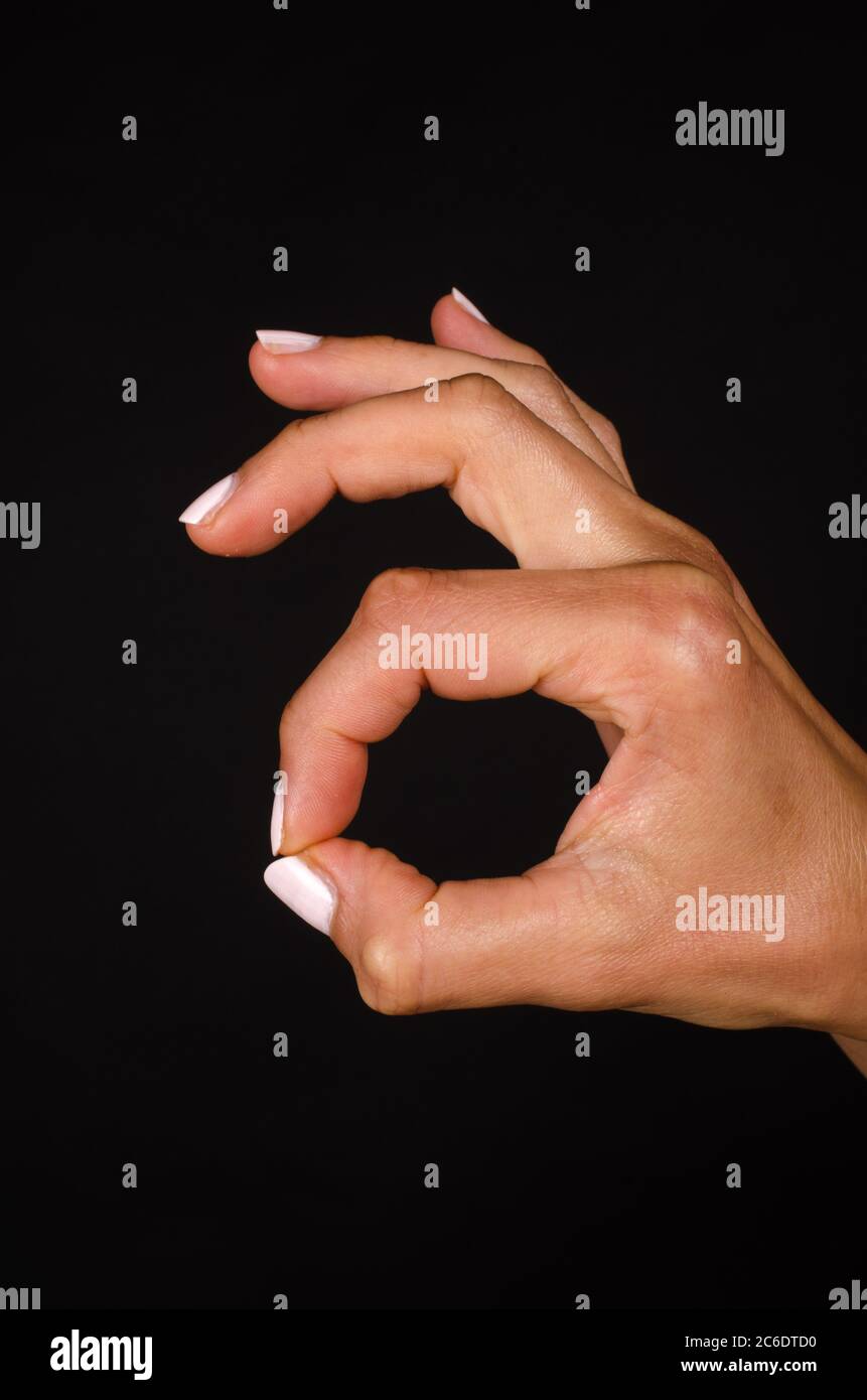 Ok gesture performed by a female hand Stock Photo - Alamy