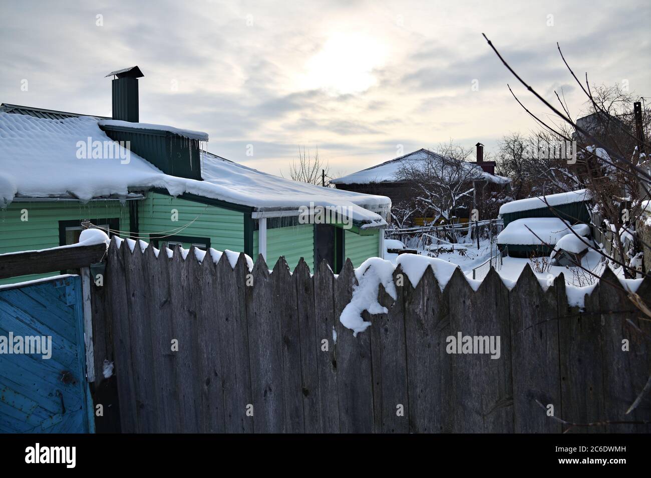 Winter in russian village, frozen wooden houses at morning time ...