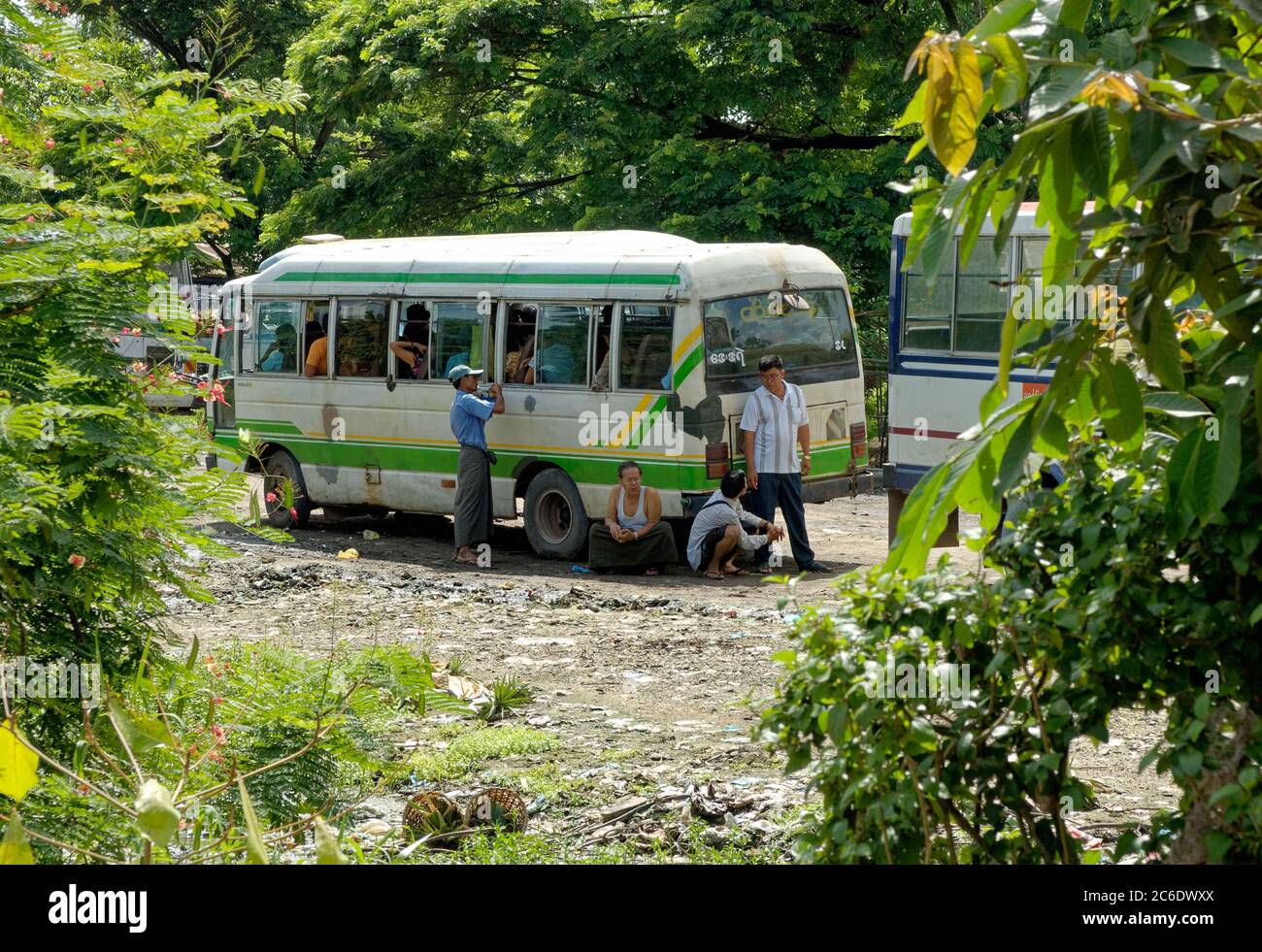Tour guides and drivers taking a break by a bus, Yangon, Myamar Stock ...
