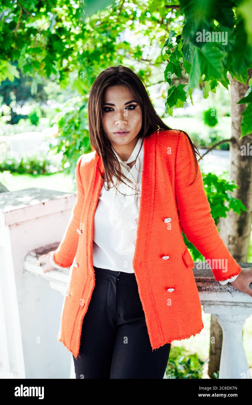 Beautiful asian woman brunette in red business suit on the street Stock ...