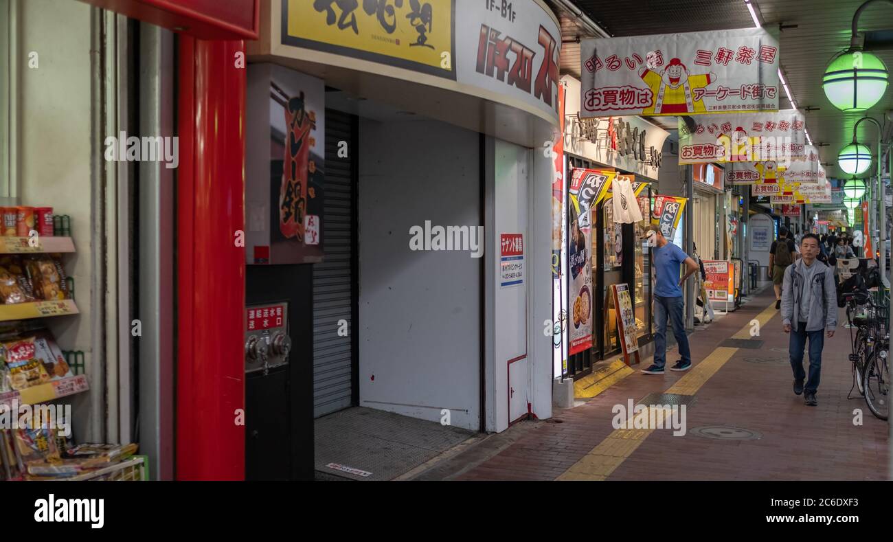 People in the sidewalk shopping street in Sangenjaya neighborhood ...