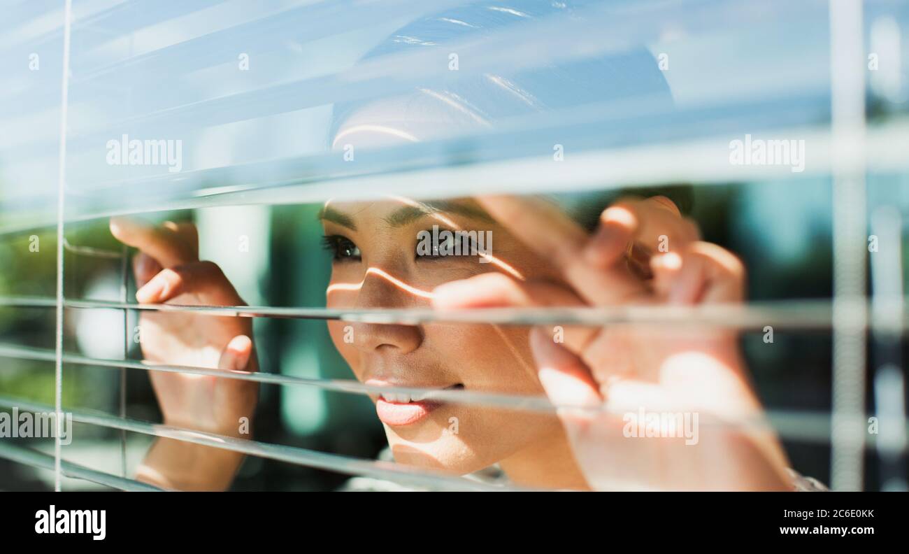 Peeking through blinds hi-res stock photography and images - Alamy