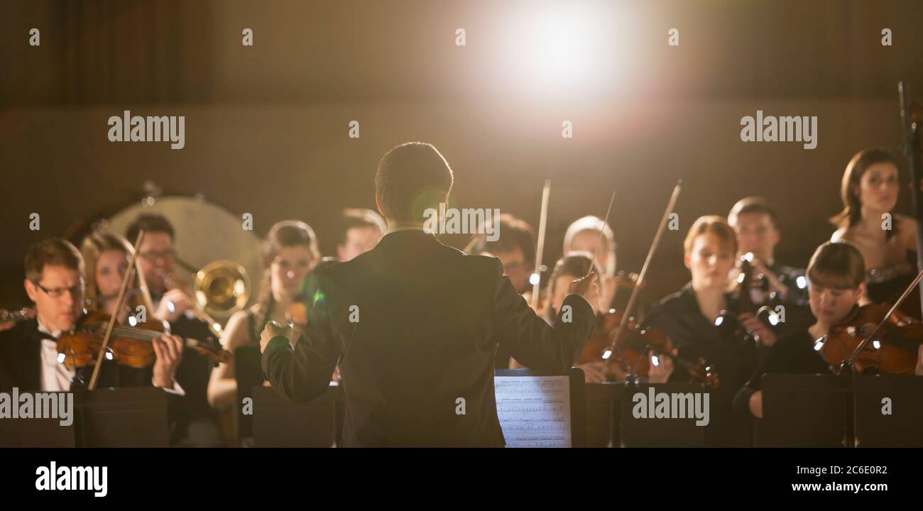 Conductor leading orchestra Stock Photo - Alamy