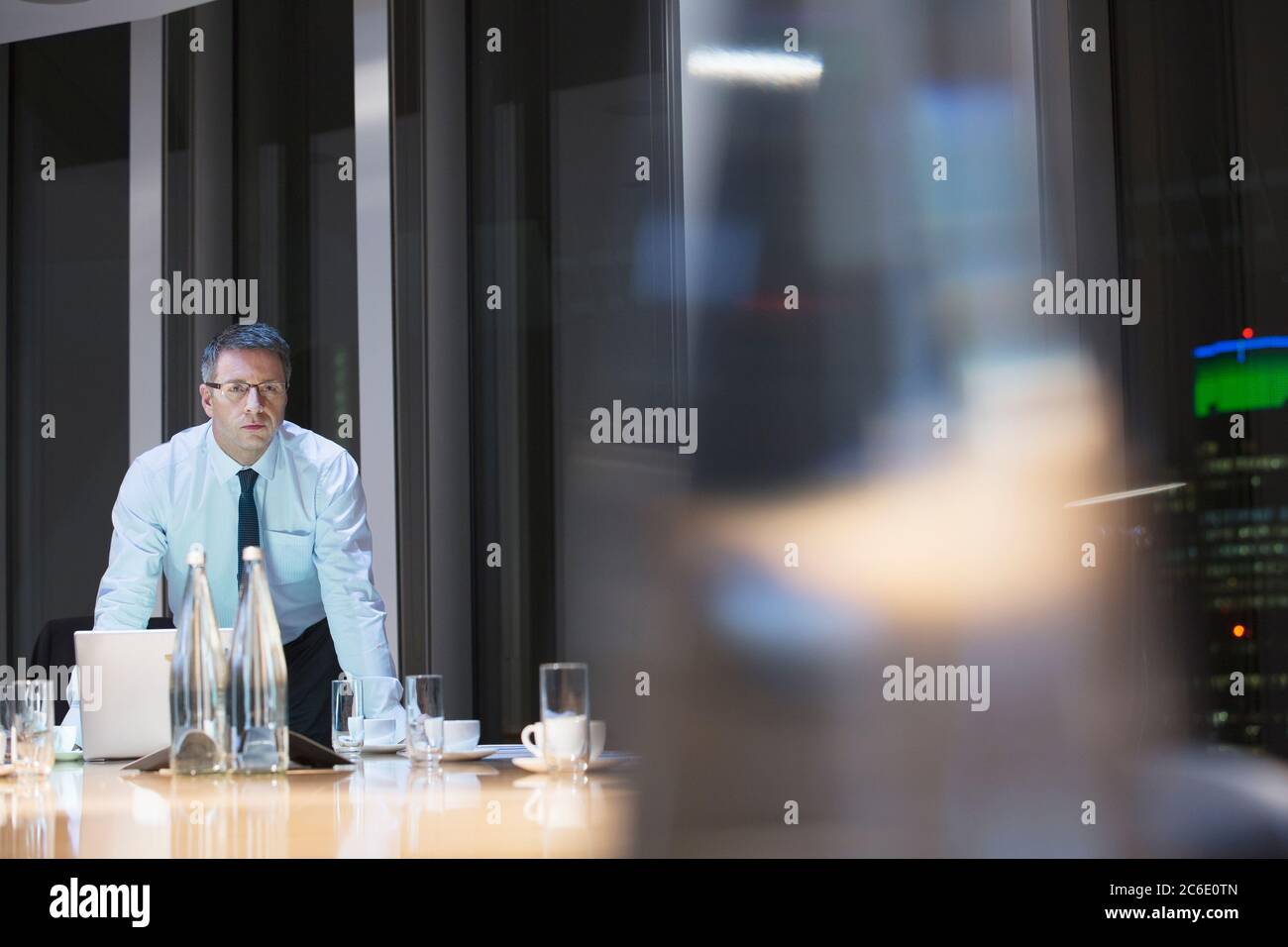 Businessman in conference room at night Stock Photo - Alamy
