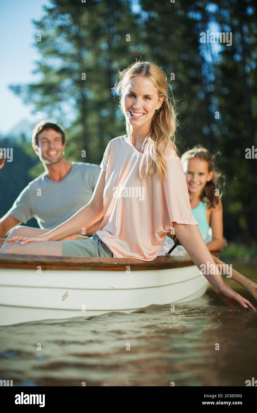 Smiling family in rowboat on lake Stock Photo - Alamy