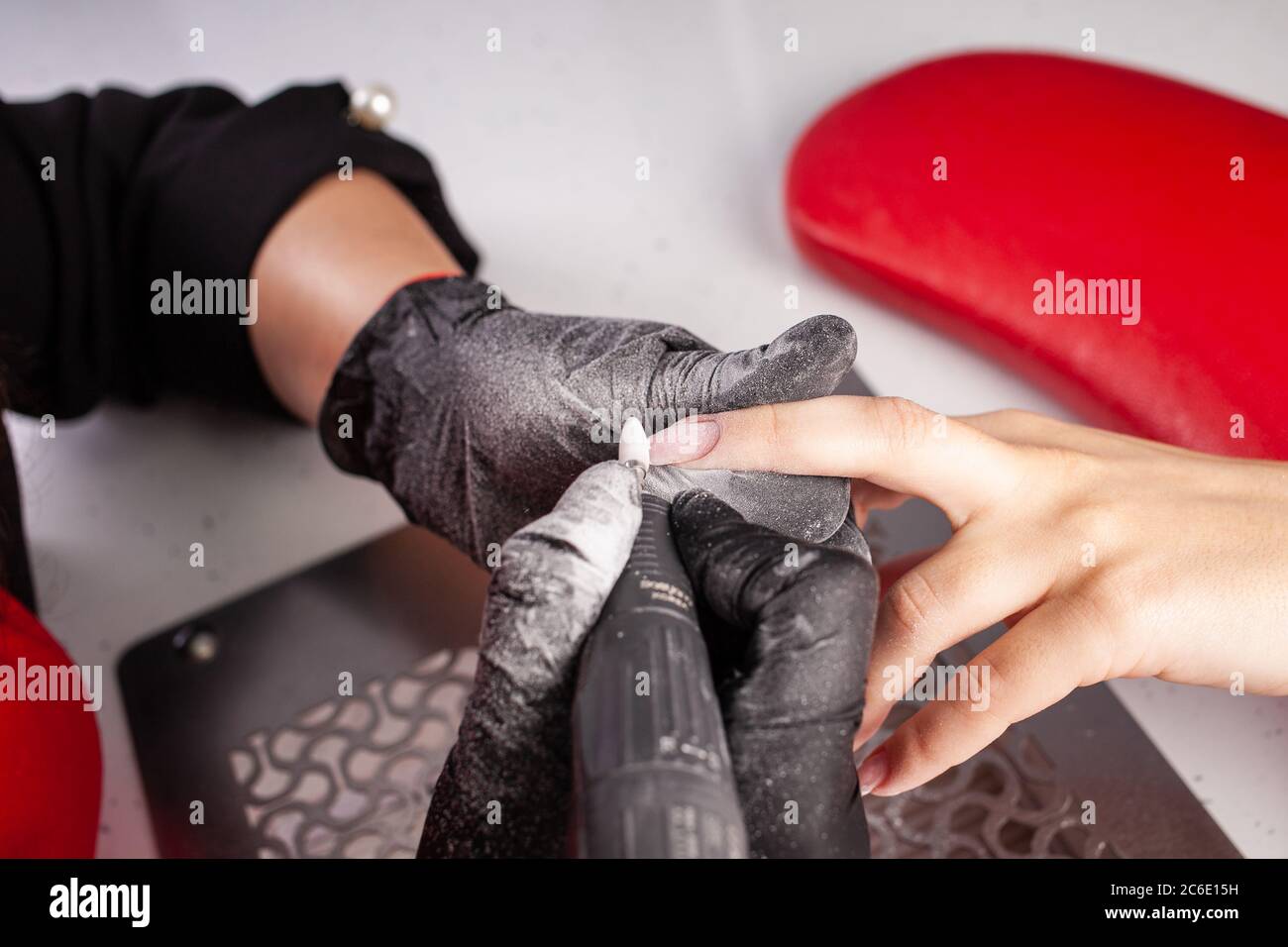 The master of manicure removes the old coating gel-lacquer. A woman ...