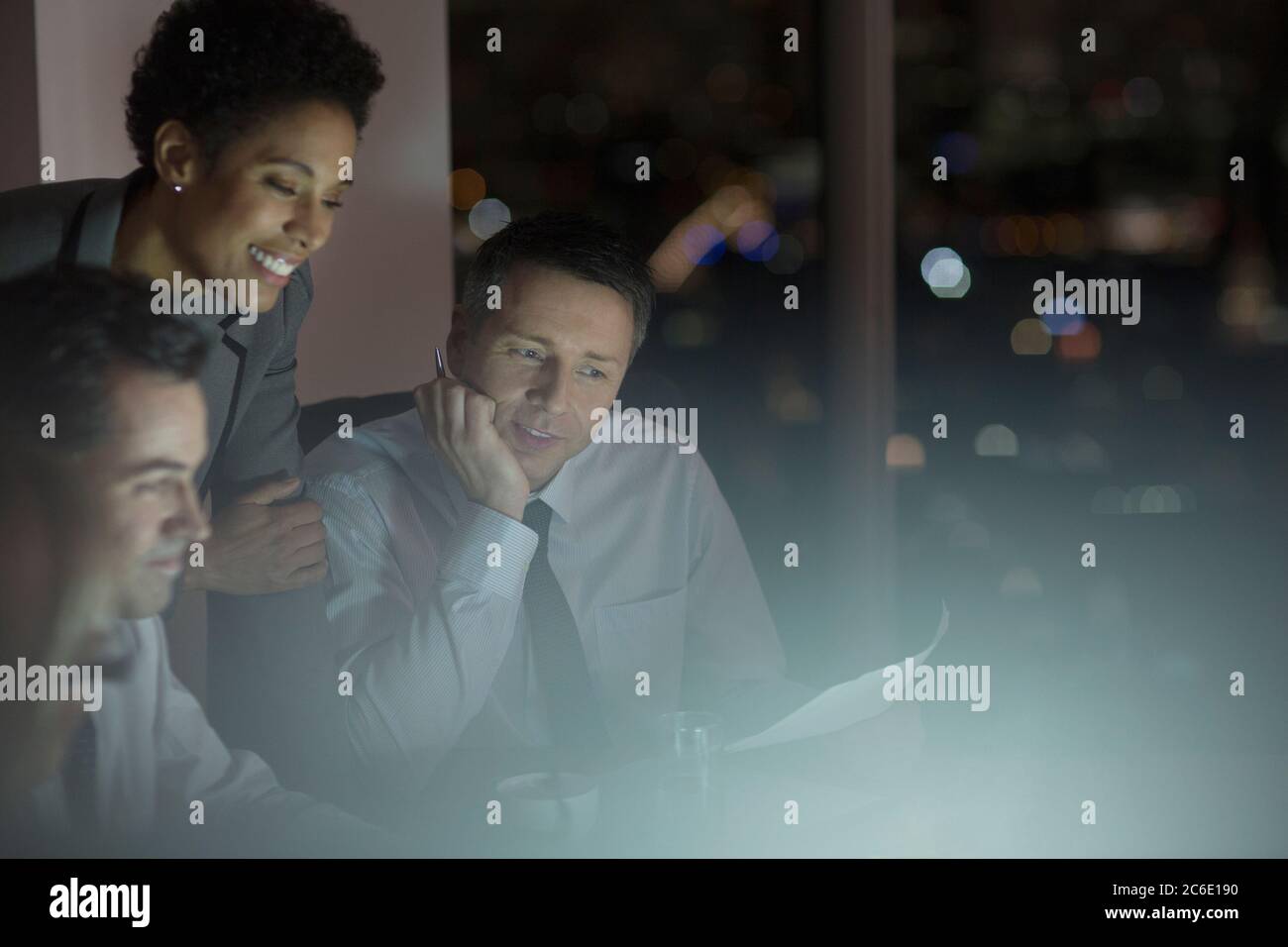 Business people working in conference room at night Stock Photo - Alamy