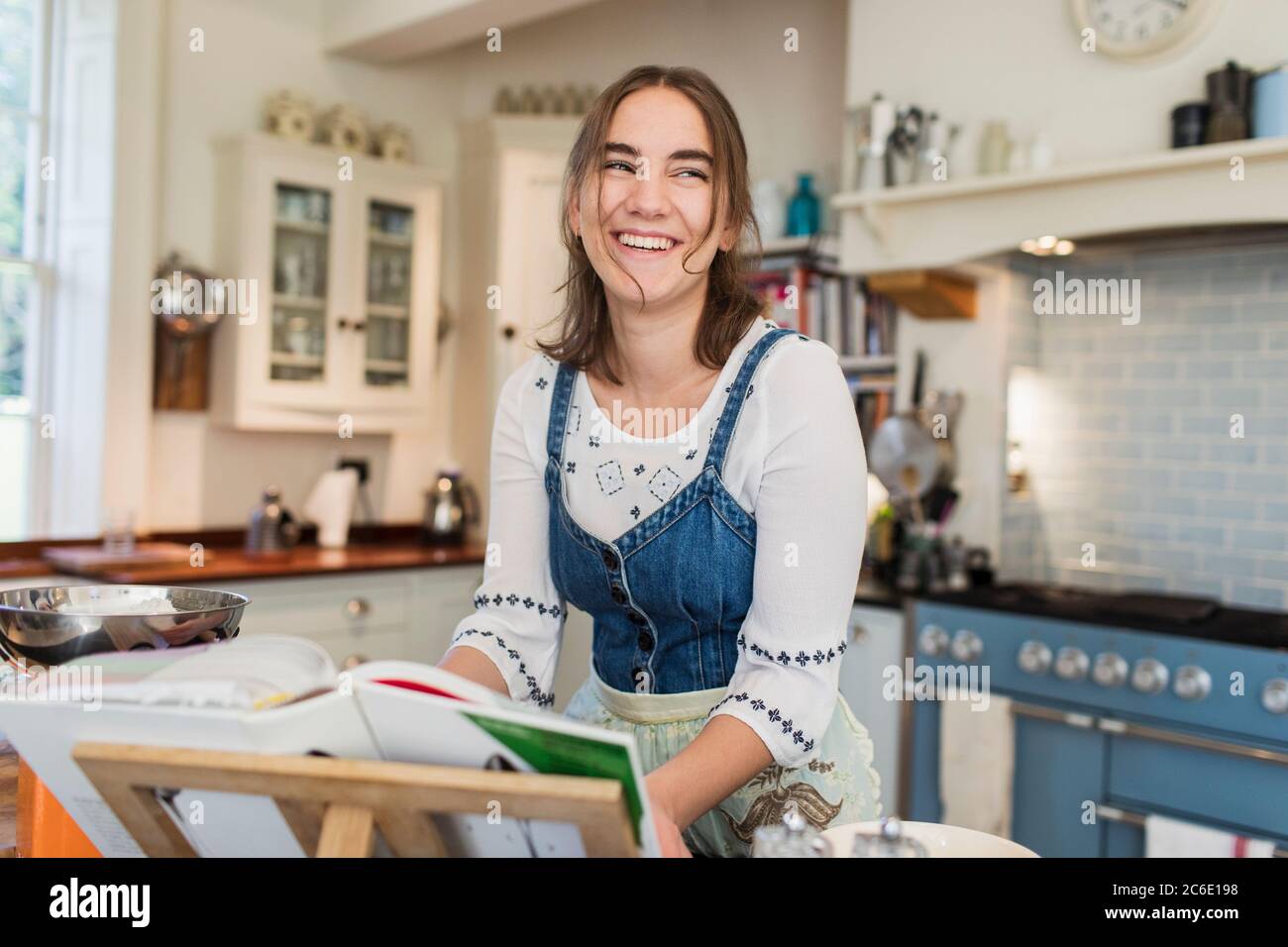 Happy teenage girl cooking in kitchen Stock Photo - Alamy