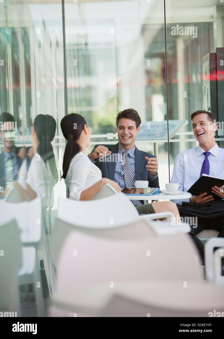 Business people laughing in cafe Stock Photo - Alamy
