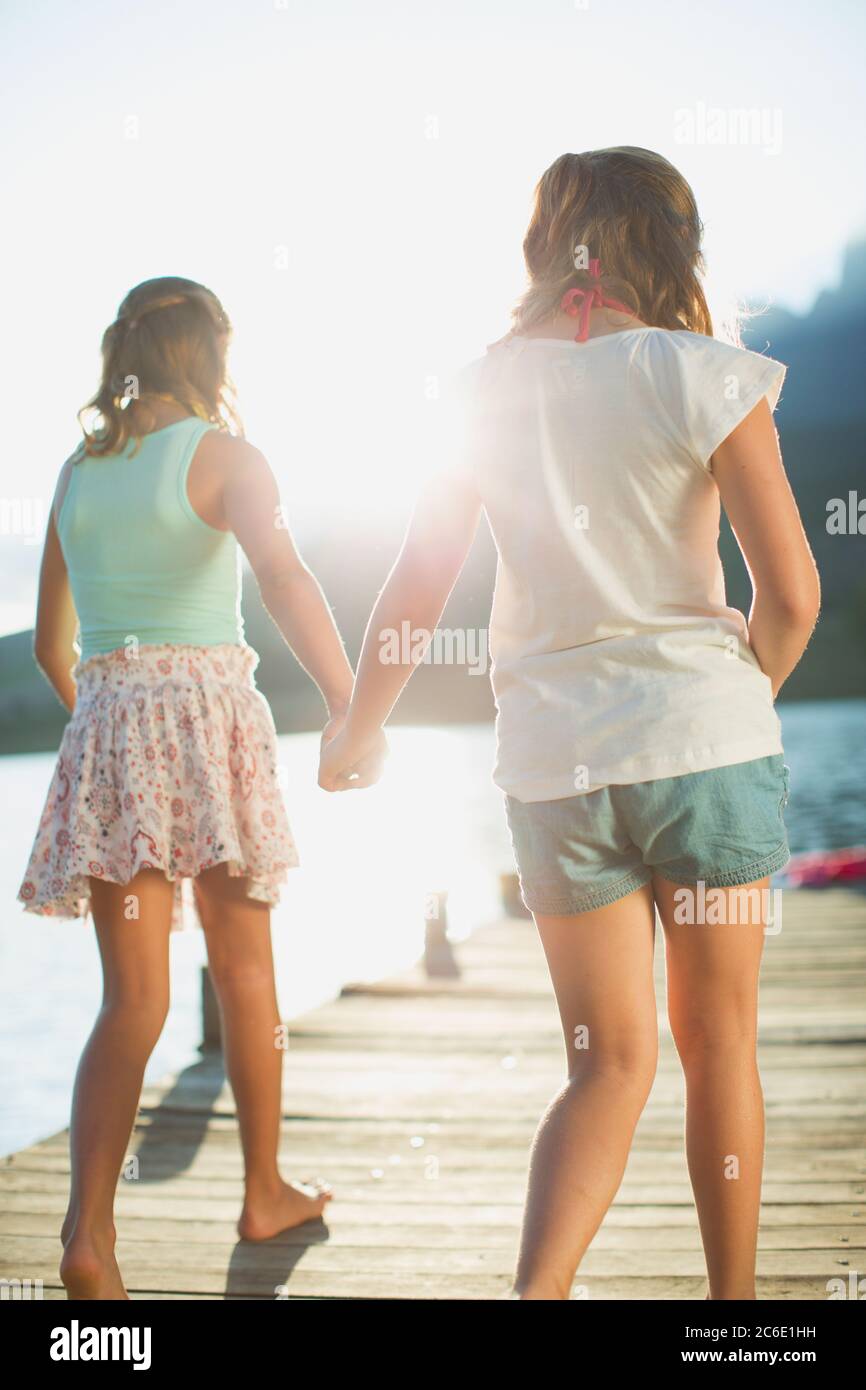 Three girls holding hands hi-res stock photography and images - Alamy