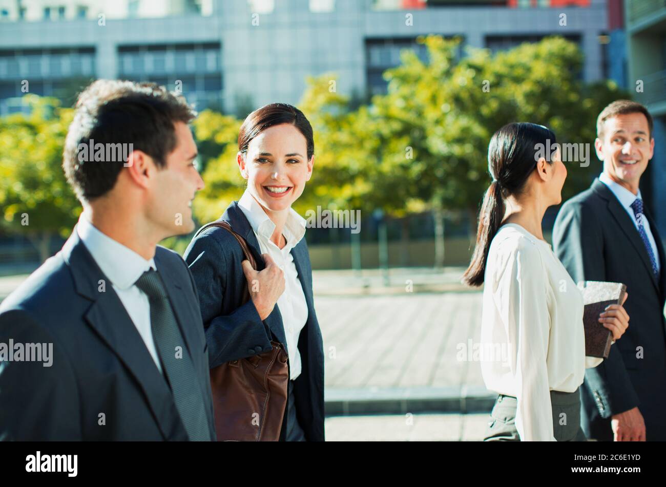 Smiling business people walking outdoors Stock Photo - Alamy