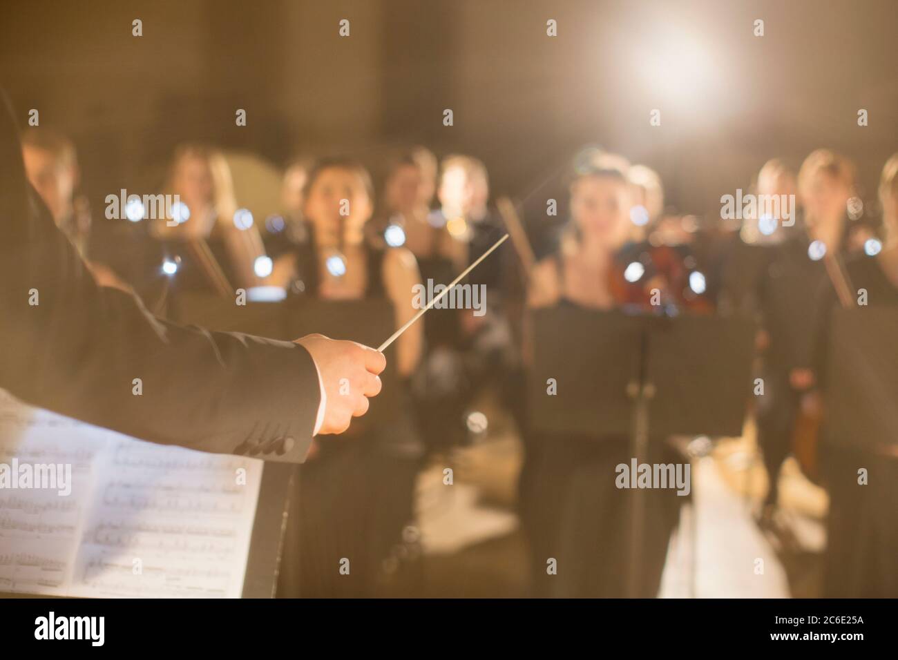 Conductor leading orchestra Stock Photo - Alamy