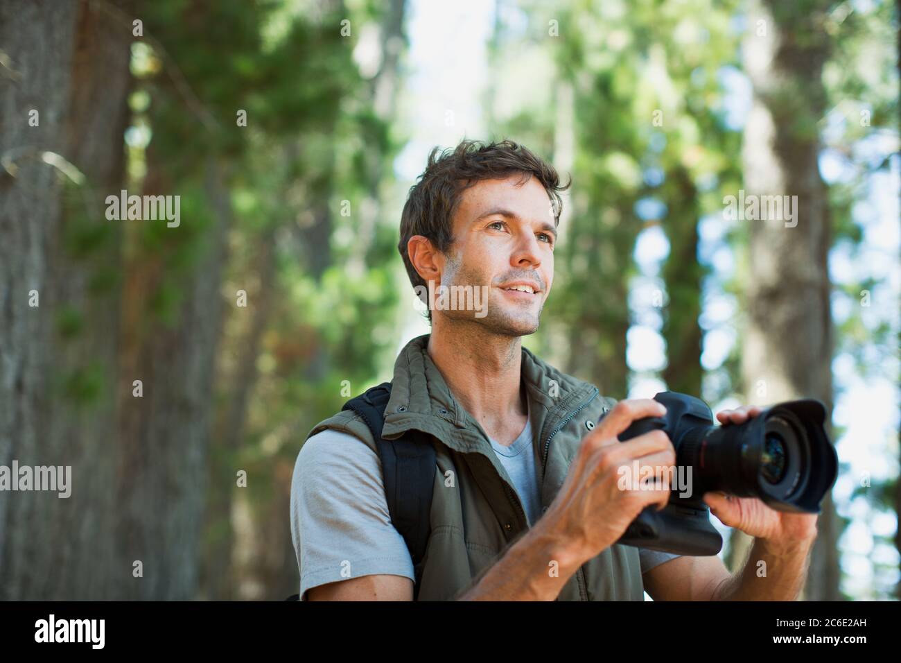 Man with digital camera in woods Stock Photo - Alamy